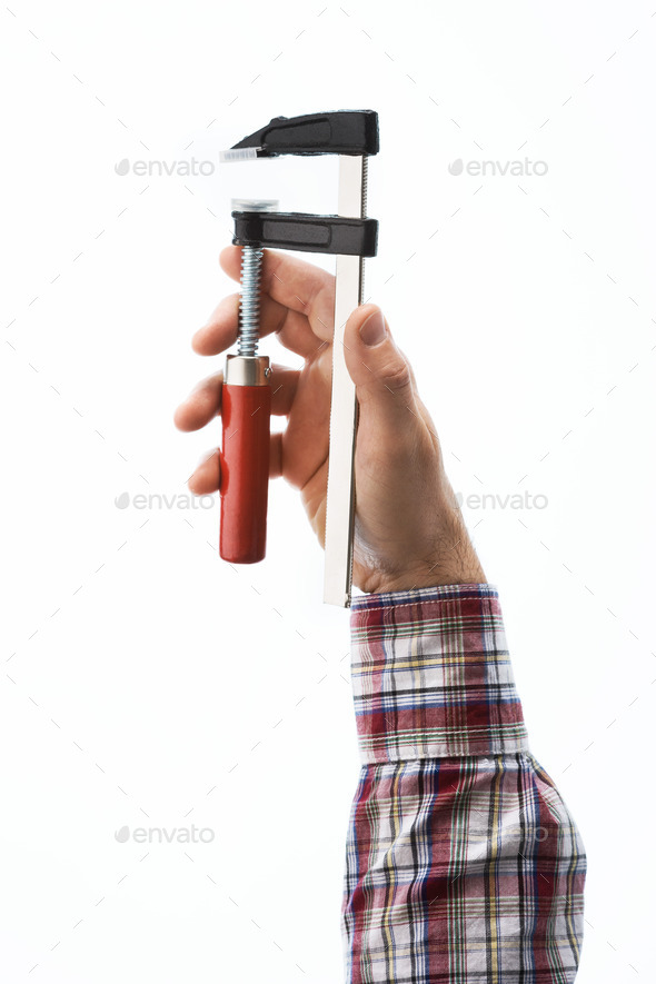 Hand holding a clamp Stock Photo by stockasso | PhotoDune