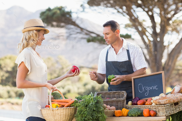 Farmer discussing with a customer at the local market Stock Photo by ...