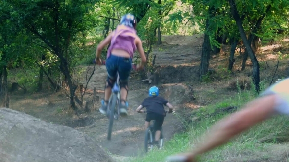 Three Cyclists Pass By The Camera, Stock Footage | VideoHive