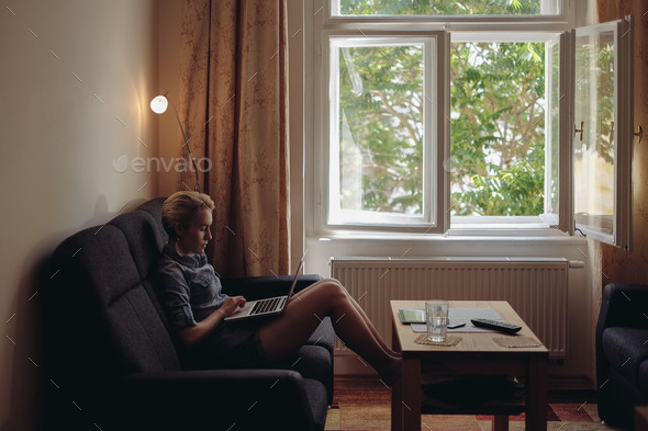 with laptop in living room Stock Photo by PaulSchlemmer | PhotoDune
