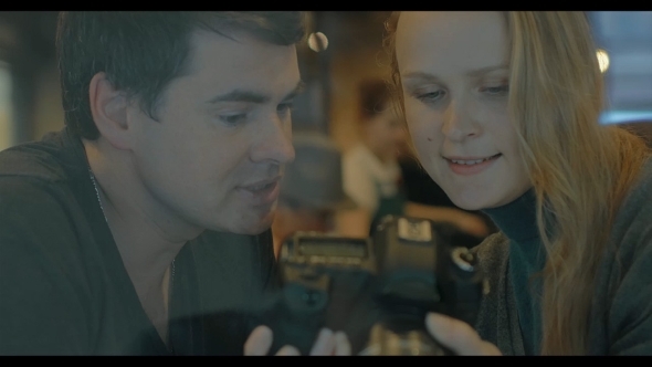 Young Couple With Camera Choosing The Best Shots, Stock Footage | VideoHive