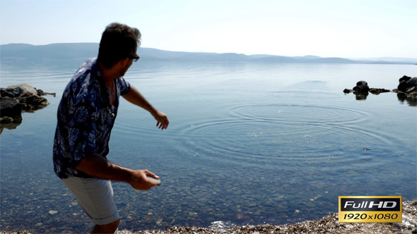 Man Throws Stone To The Sea, Stock Footage | VideoHive