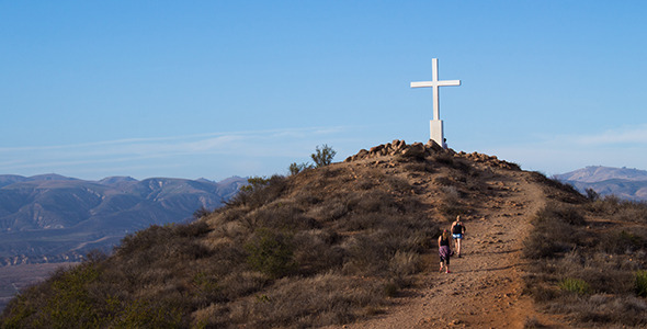 Hikers Trek to Mountaintop Cross by KMJARRETT | VideoHive