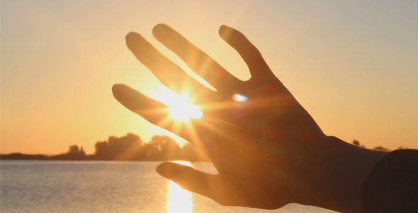 Girl Playing a Hand With Sun Rays at Sunrise, Stock Footage | VideoHive
