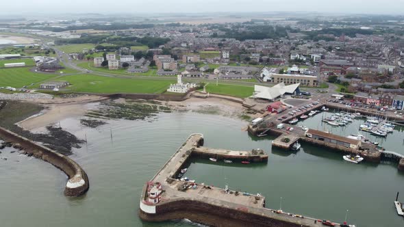 Drone View of Arbroath Harbor with a Pier and Views of the North Sea ...
