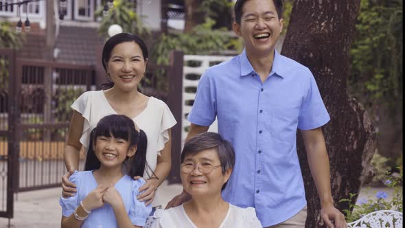 Asian Multi Generational Family Looking at Camera and Smiling at Home ...