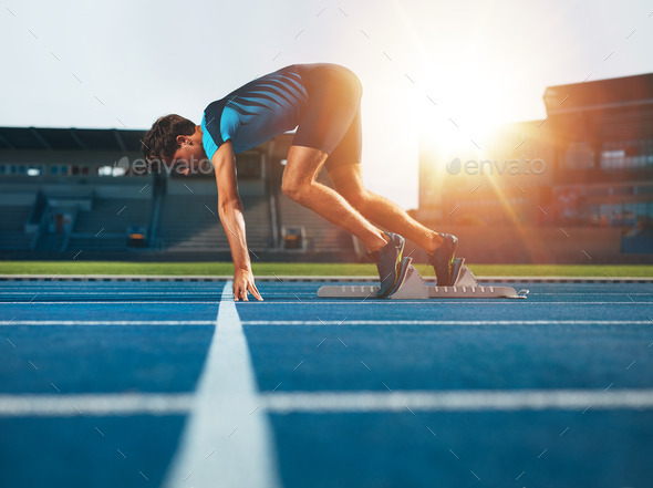 Professional male track athlete in set position Stock Photo by jacoblund