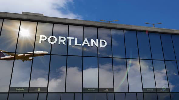 Airplane landing at Portland Oregon, USA airport mirrored in terminal ...