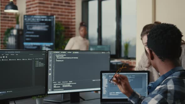 Programmer Analyzing Compiling Code on Multiple Screens Takes Off ...