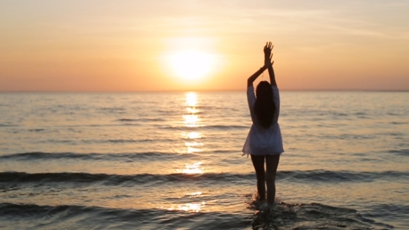 a Girl Walks Into The Sea At Sunset, Stock Footage | VideoHive