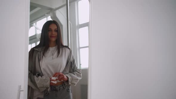 Attractive Woman Primping Herself in Front of Mirror, Stock Footage