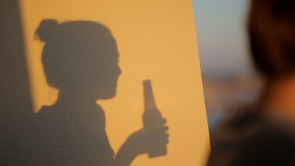 Shadow Silhouette Of a Woman Drinking From Beer, Stock Footage | VideoHive