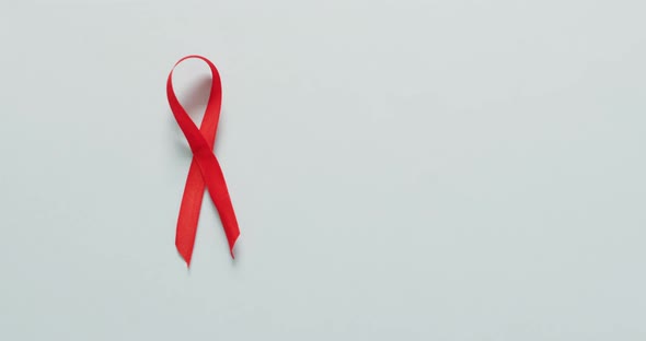 Video of red blood cancer ribbon on pale blue background, Stock Footage