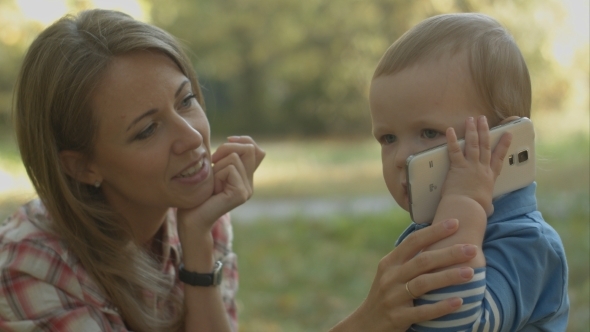 Mother Helps Little Son To Call His Father, Stock Footage | VideoHive