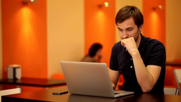 Man Uses a Laptop To Search For Information, Stock Footage | VideoHive