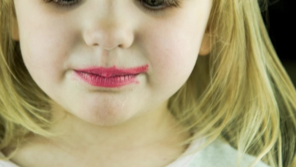 The Little Cute Girl Makes Up Lips With Red, Stock Footage | VideoHive