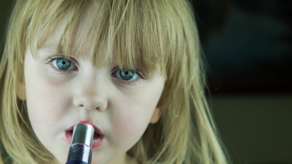 The Little Cute Girl Makes Up Lips With Red, Stock Footage | VideoHive