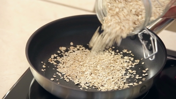 Chef Is Drying Oat-Flakes On a Frying Pan, Stock Footage | VideoHive