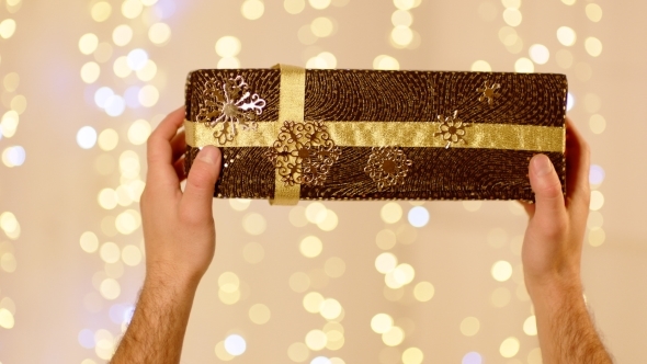 Brown Gift Box With Golden Ribbon And Snowflakes, Stock Footage | VideoHive