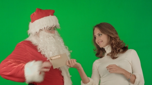 Happy Santa Claus With His Woman Helper Reading, Stock Footage | VideoHive