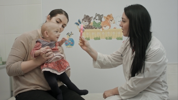 Cute Baby Being Examine By Pediatrician With Toy, Stock Footage | VideoHive