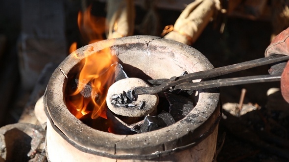 The Blacksmith Lays the Ore into the Crucible, Stock Footage | VideoHive