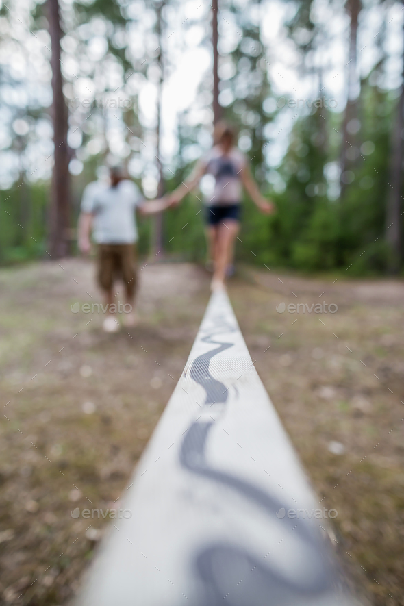 Learning to walk on a tightrope, and keep the balance. Stock Photo by ...