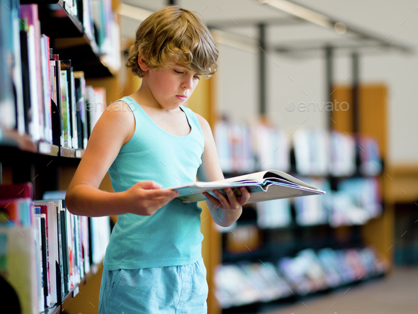 Boy in library Stock Photo by nexusplexus | PhotoDune