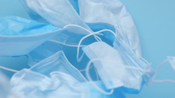 Falling Down Masks on the Blue Background. Discarded Surgical Masks ...