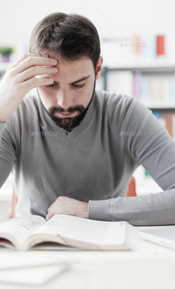 Man studying at the library Stock Photo by stokkete | PhotoDune