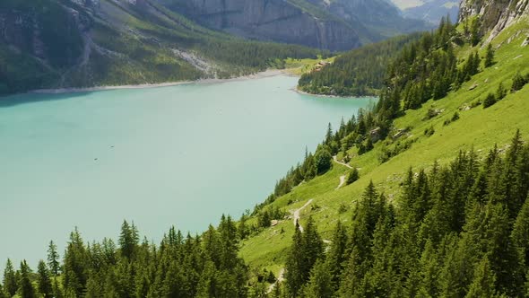 Aerial of beautiful Swiss landscape with a blue lake. Tilting up to ...
