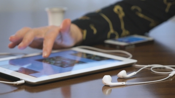 Female Hands Flipping Through a Food Magazine Using a Digital Tablet ...