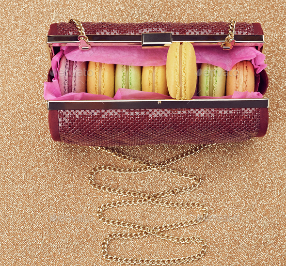 Macarons in shiny fashion handbag on gold.Vintage Stock Photo by 918Evgenij