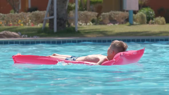Young Joyful Child Boy Having Fun Swimming on Inflatable Air Mattress ...