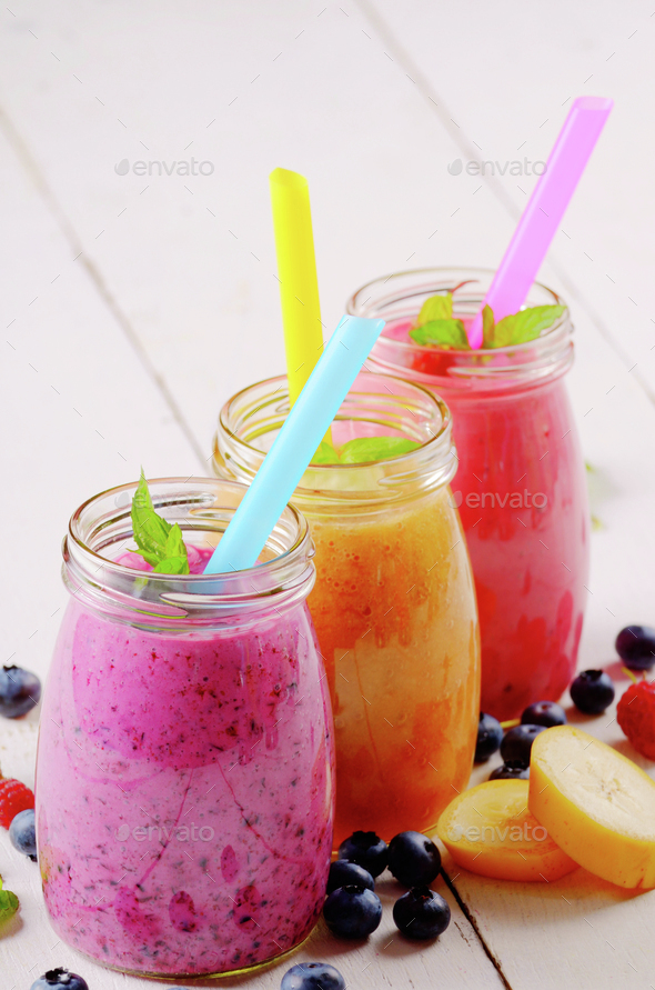 Assorted fruit shakes on white table Stock Photo by Olena_Mykhaylova