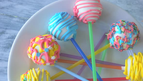 Colored Cake Pops on White Plate, Stock Footage | VideoHive
