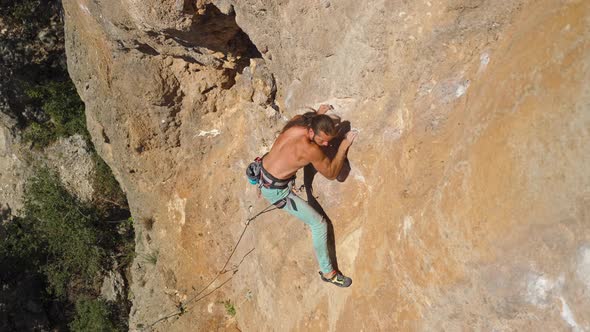 Young Strong Athletic Man Rock Climber with Long Hair Climbing on ...