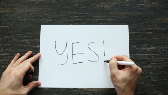 Man Hand Writing Yes With Black Marker On White Paper. Top View, Stock ...