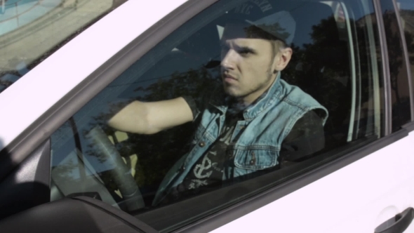 Young Man In Cap, Jacket Inside Car In Traffic Jam Waiting, Stock Footage