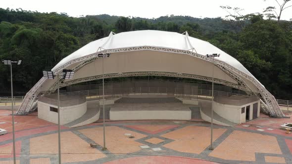 Aerial view that slowly goes from the front of an open stage podium ...