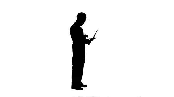 Silhouette Portrait Of An Engineer In Helmet Using a Laptop Track Matte ...