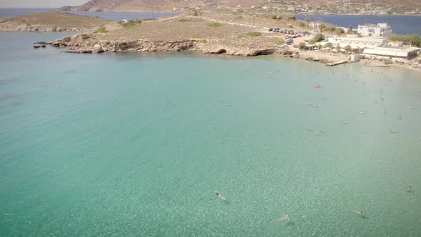 Aerial view of people swimming on beach Alithini, Syros island in ...