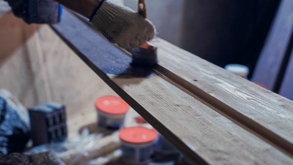 Process Of Painting The Pine Wood Boards With The Brush And The Purple ...