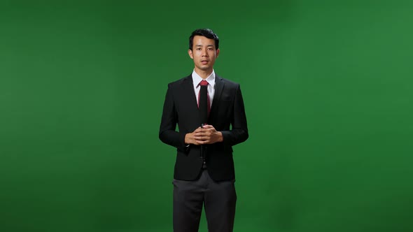 Asian Man Journalist And Tv Presenter Speaks Into A Microphone On A ...