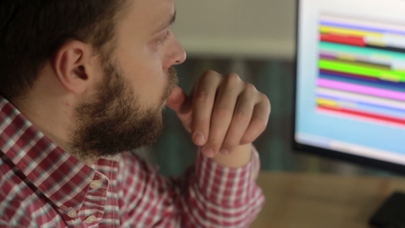 Man Looking At Graphs On The Computer Monitor, Stock Footage | VideoHive