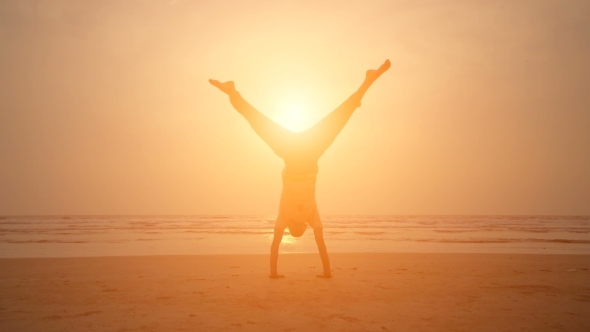 Man Doing Yoga During Sunset On The Beach, Stock Footage | VideoHive