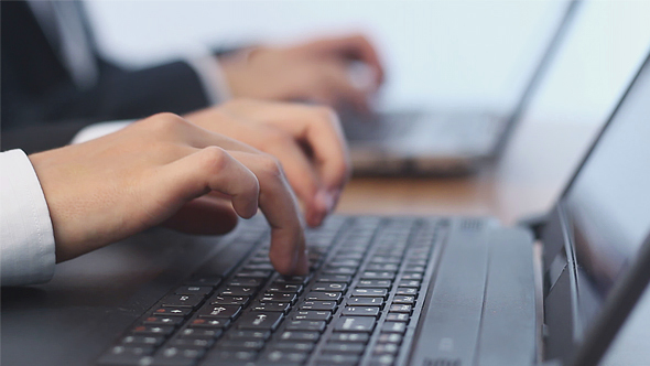 Business People Typing on a Laptop in the Office, Stock Footage | VideoHive