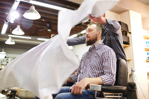 Visiting barbershop Stock Photo by Pressmaster | PhotoDune