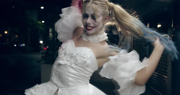 Talented Female Dancer in Scary Costume Holding Pigtails and Dances in ...