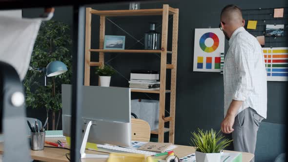 Portrait of Creative Guy Designing Logo for Smartphone App Choosing ...